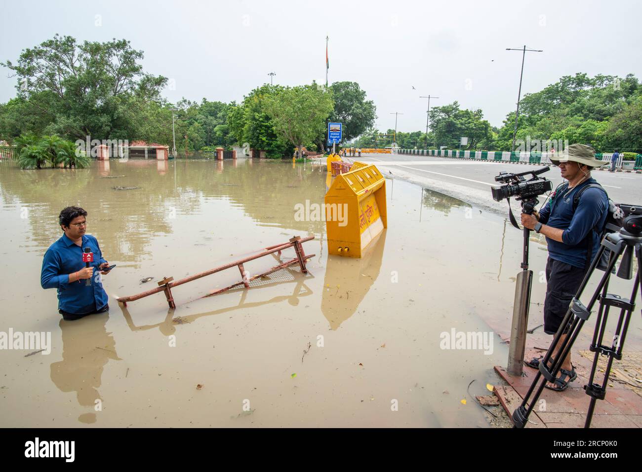 New Delhi, India. 15th July, 2023. Cameraman and TV reporter seen covering Delhi flood from ...