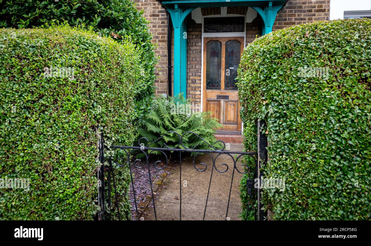 The front yard, garden and front door of an English style countryside ...