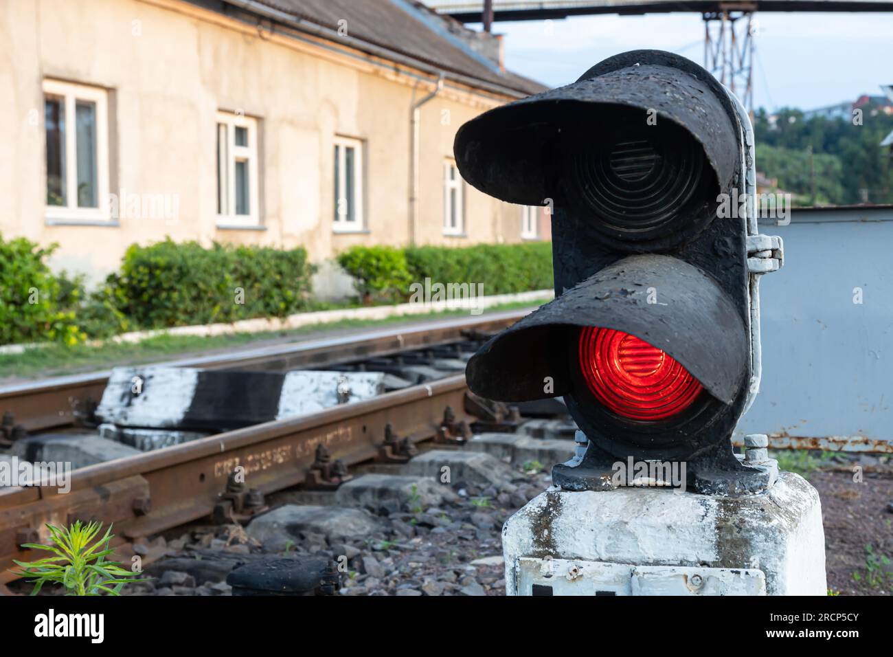 Piece of equipment shining a red light next to the train tracks Stock ...