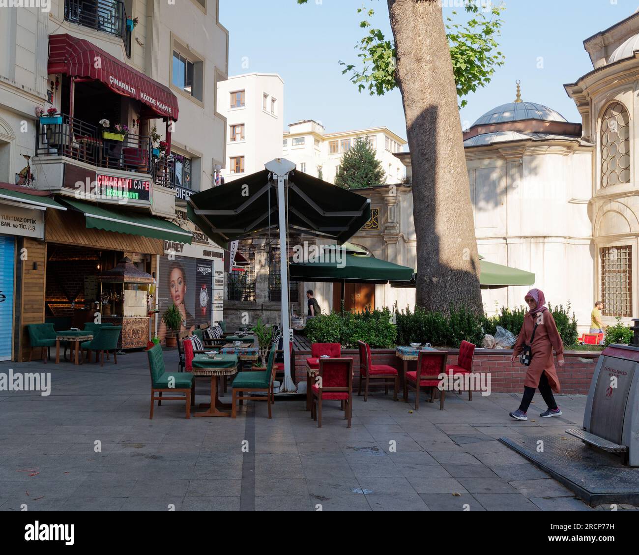 Cafe/restaurant with green and red chairs on a summers morning as a ...
