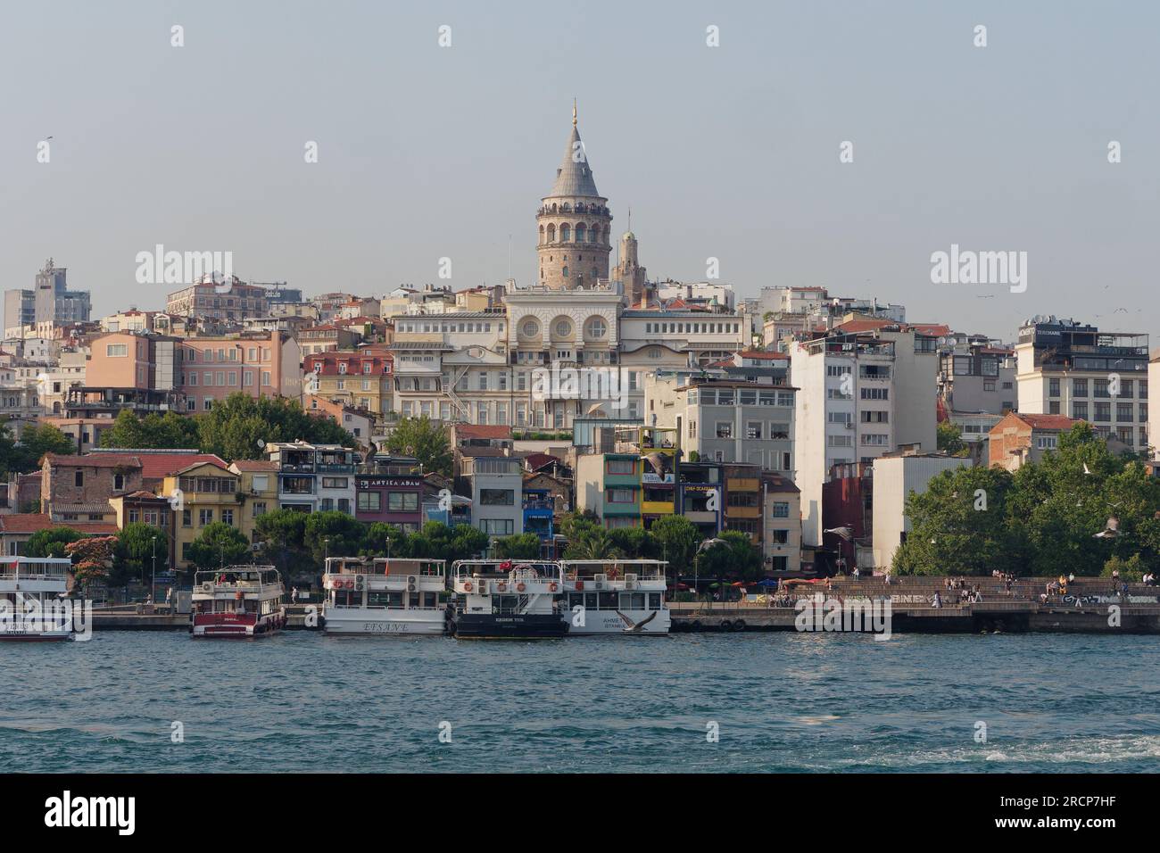 Private boats moored on the Golden Horn Waterfront as people enjoy a ...