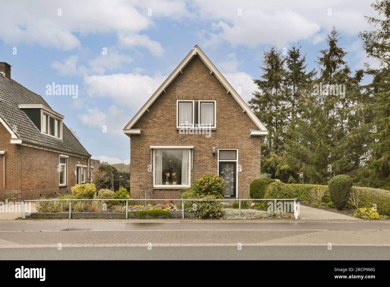 two houses in the same neighborhood, one is red brick and the other is ...