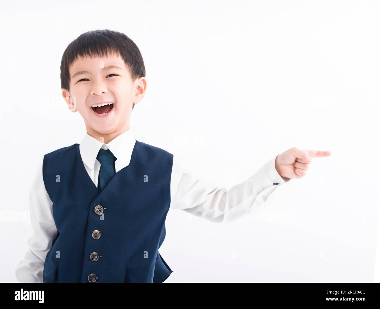 Happy boy pointing finger away at copy space Stock Photo - Alamy