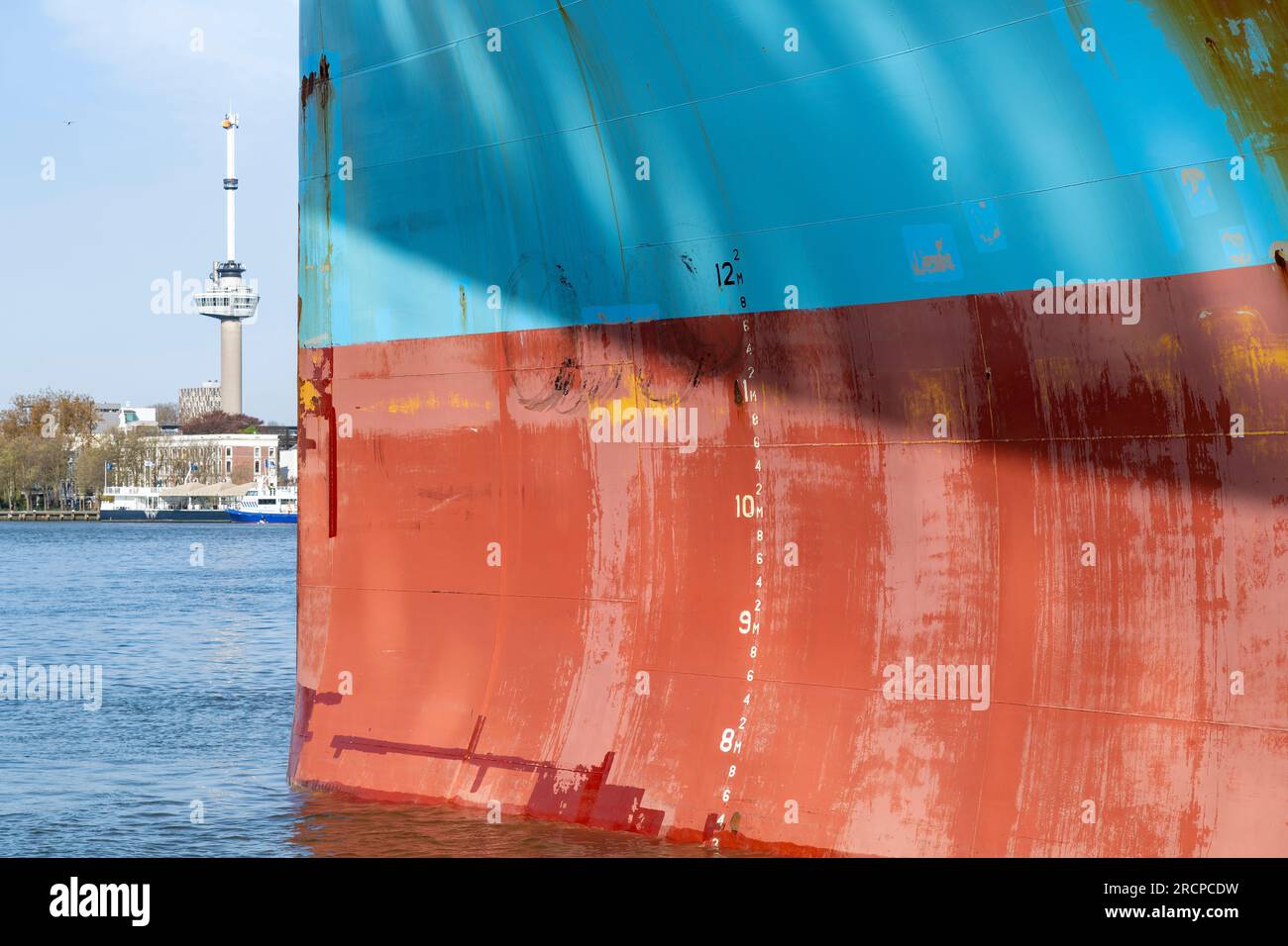Close up view of the red and blue colored bow a ship with anchor hole ...