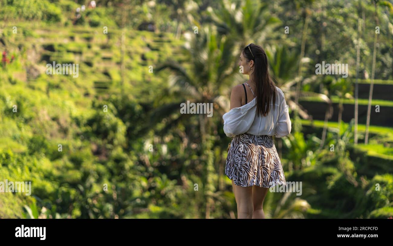 Back view of young stylish lady with rice terrace background ...