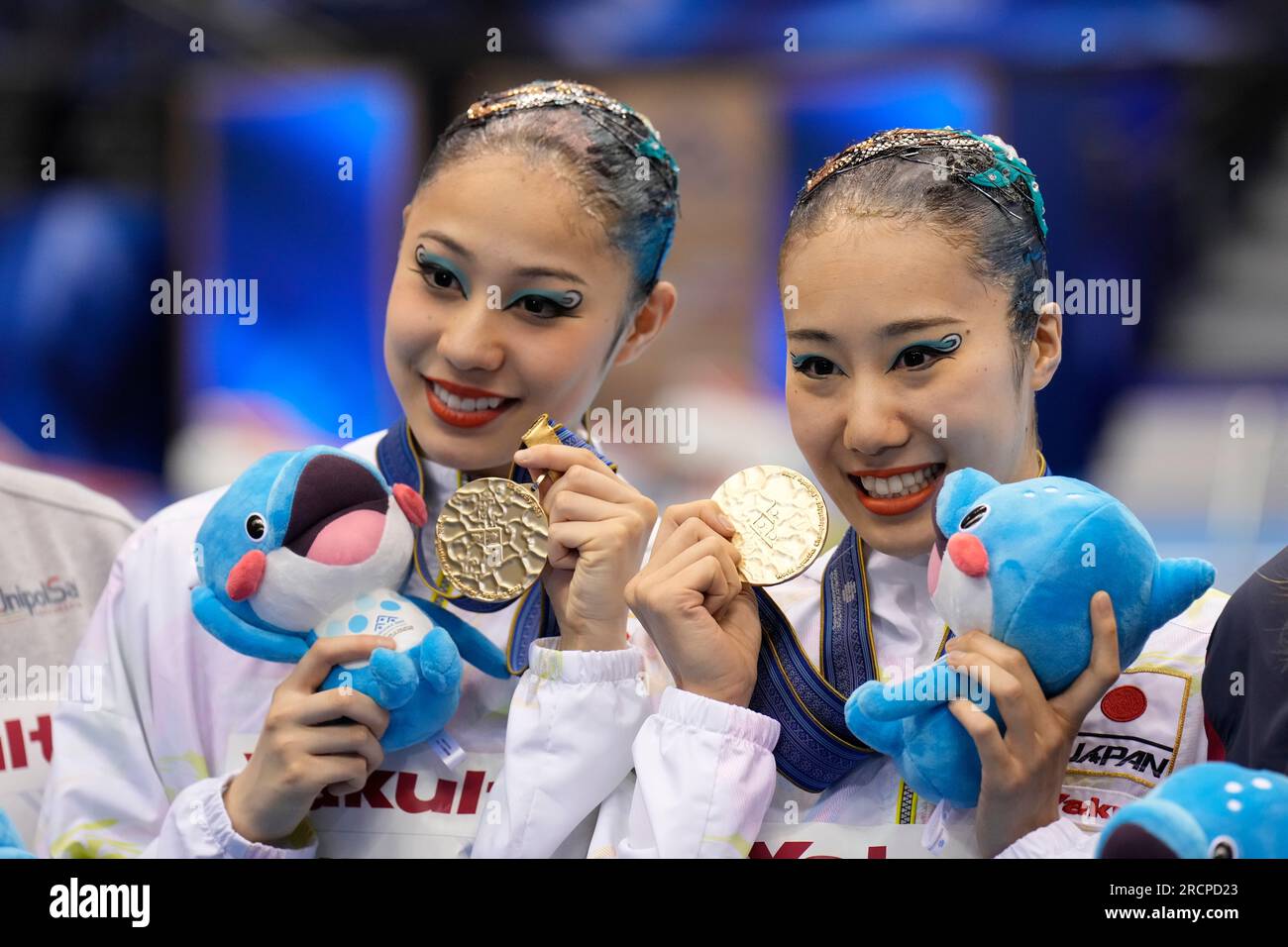 Mashiro Yasunaga and Moe Higa, of Japan, hold their gold medals after winning the women's duet ...