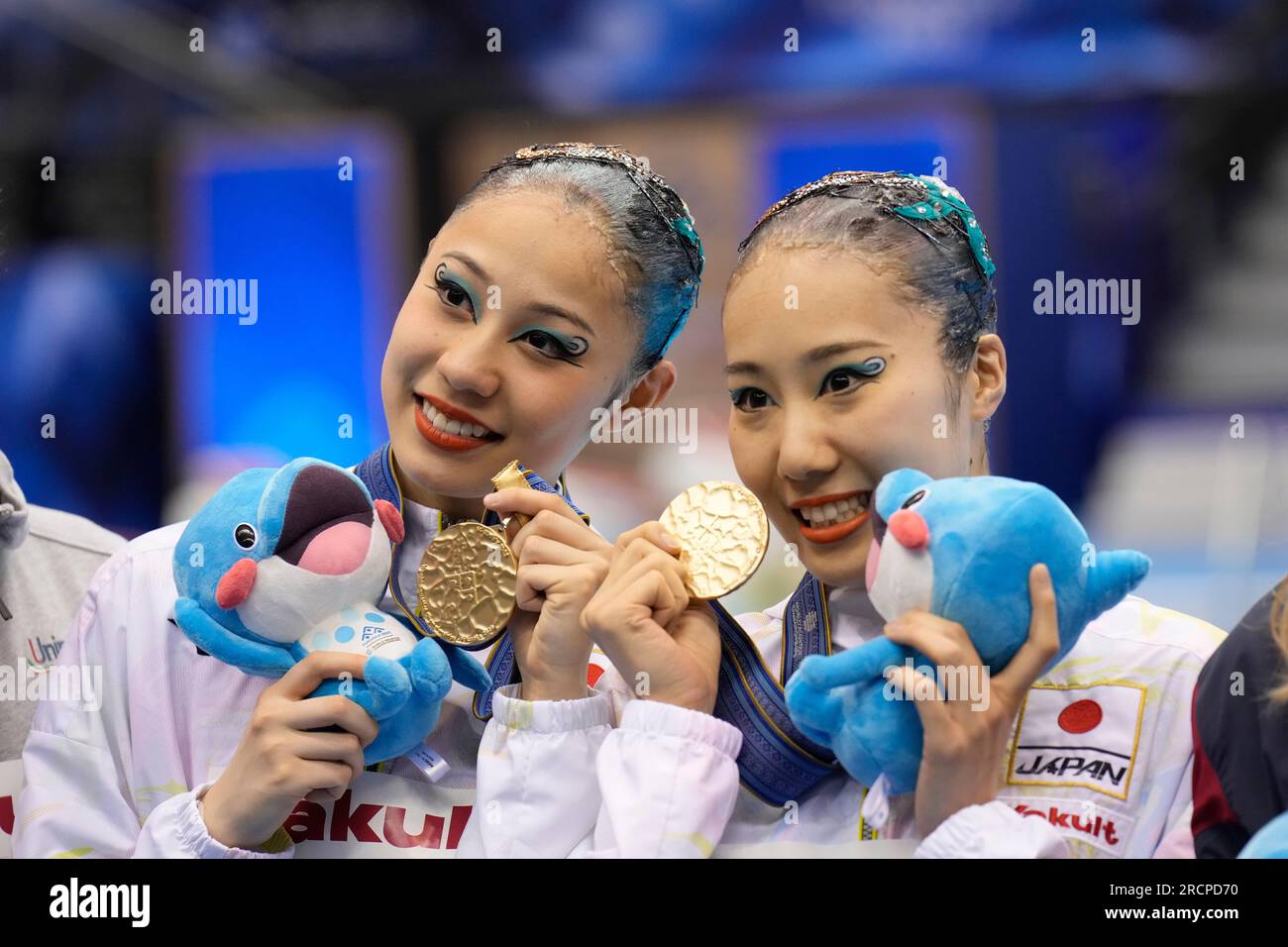 Mashiro Yasunaga and Moe Higa, of Japan, hold up their gold medals ...