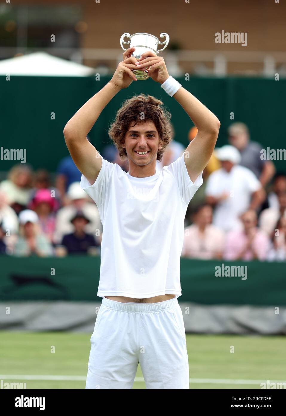 Mark Ceban celebrates with the trophy following the Boys 14 & Under ...