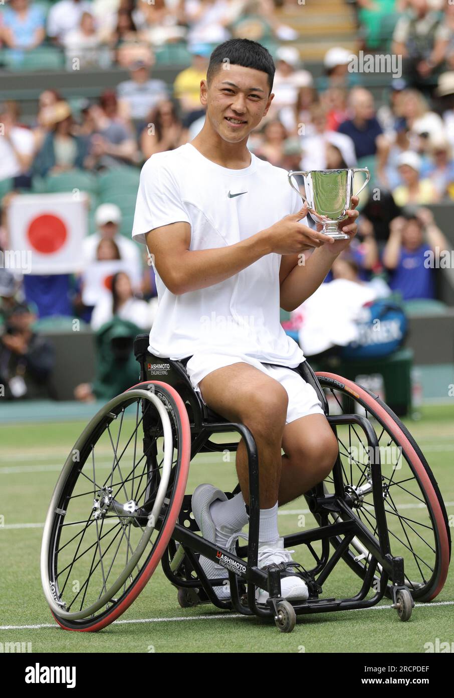 Tokito Oda of Japan holds a victory trophy during an award ceremony of ...