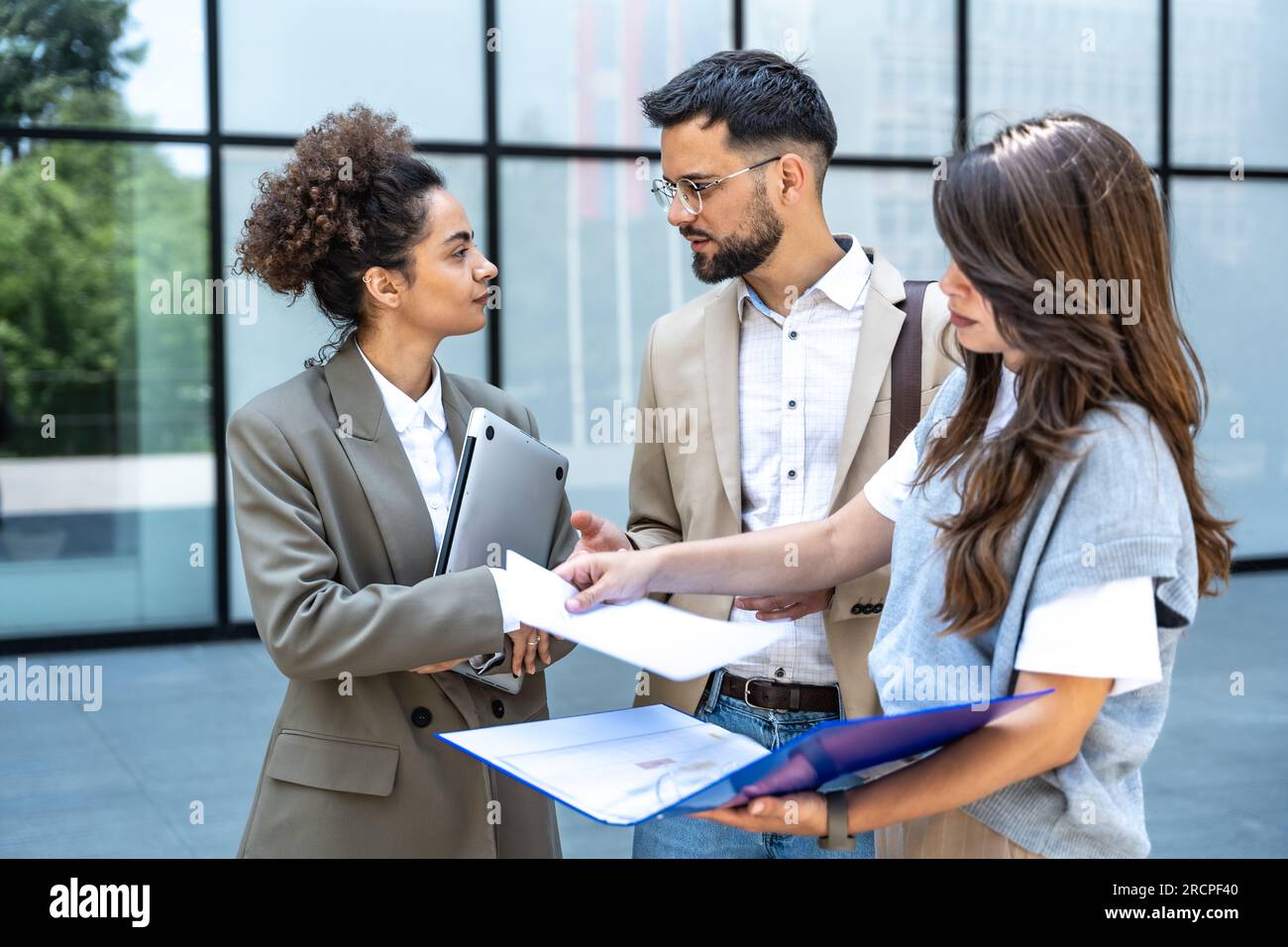 Team of business people talking in front of office building. Staff ...