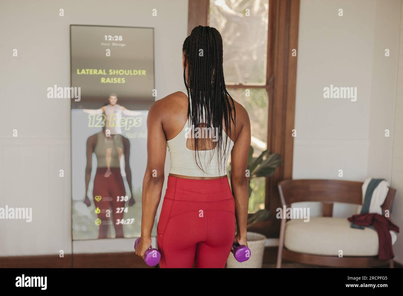 With the help of a virtual instructor on a smart fitness mirror, a ...