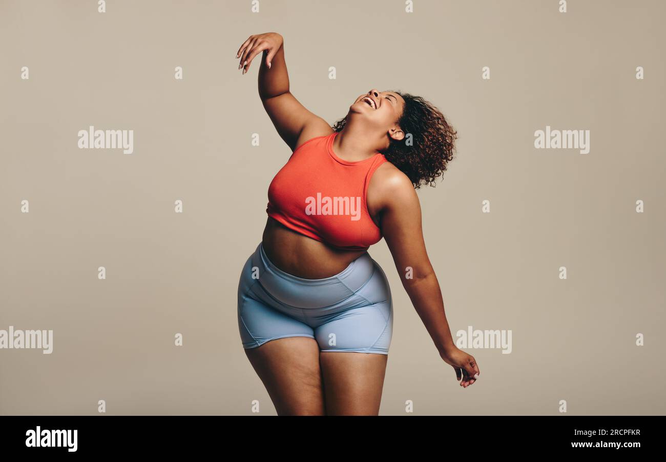 Fit Plus Size Woman Confidently Displays Her Sportiness And Flexibility