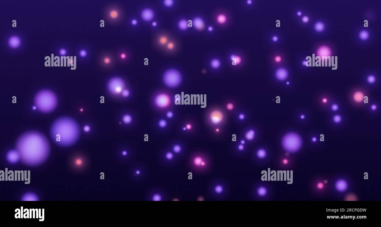 Blue and purple sparkling particles swirling in the air on a blue ...