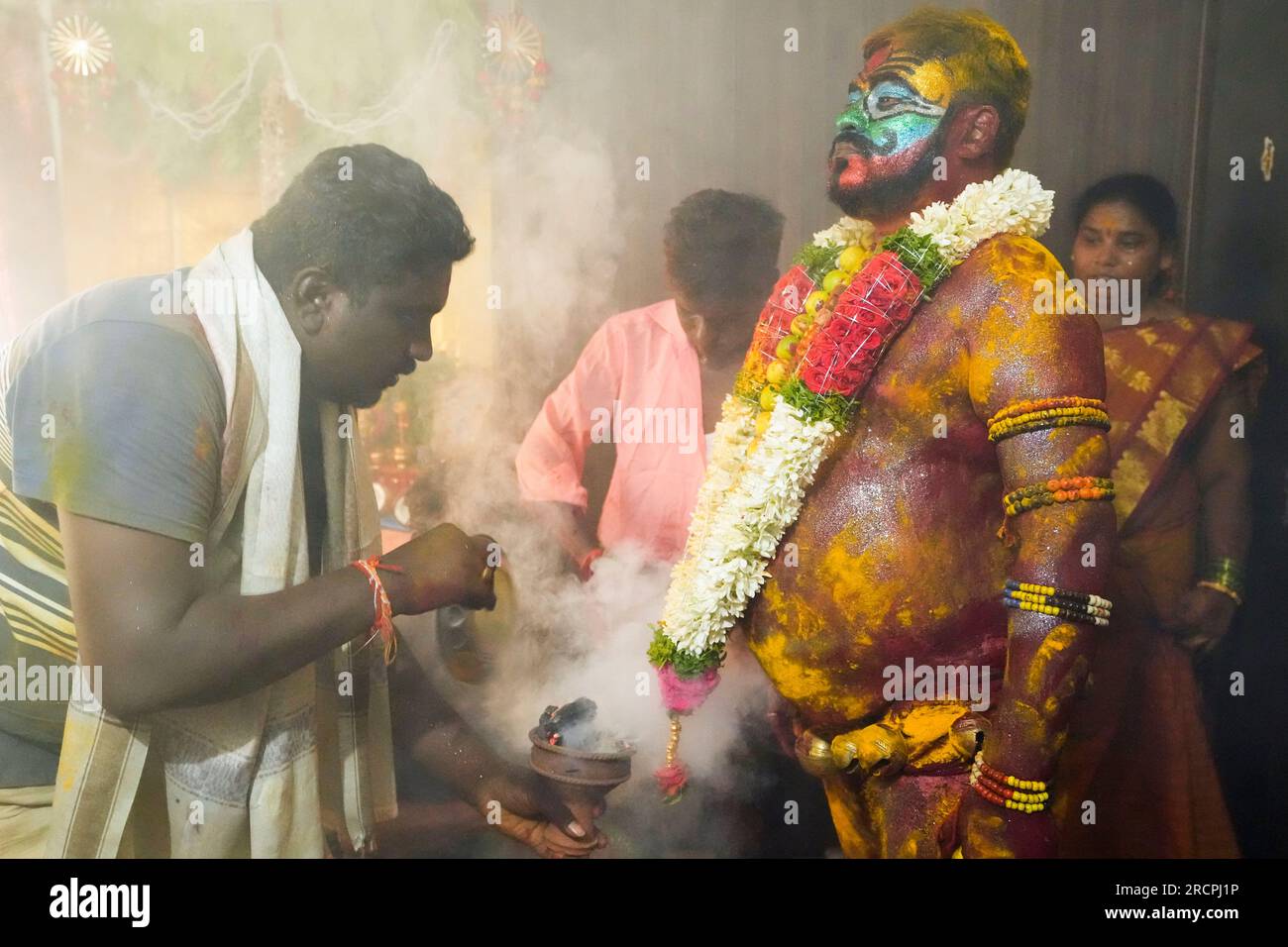A devotee gets ready to play the role of Pothuraju, a mythical ...