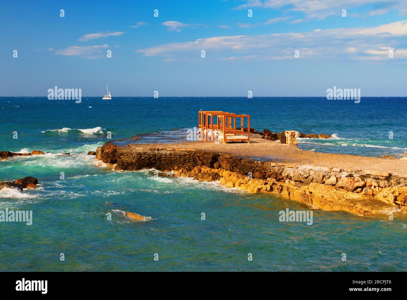 Beach and jetty with pergolas in the resort of Hersonissos on the ...