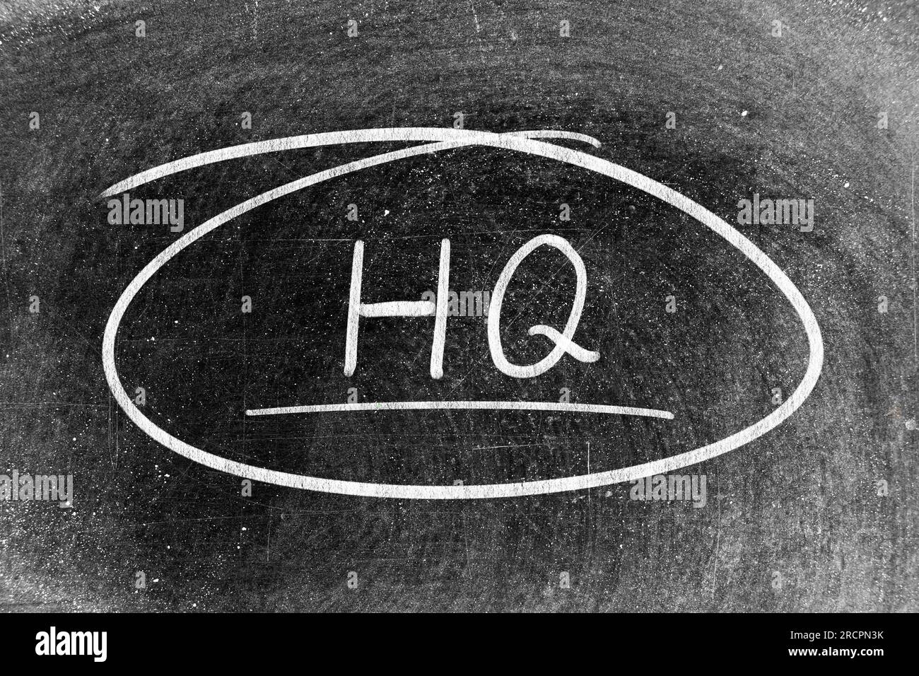 White chalk hand writing in word HQ (Abbreviation of headquarters) and ...