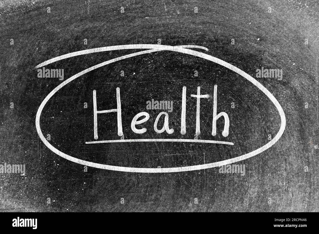 White chalk hand writing in word health and circle shape on blackboard ...