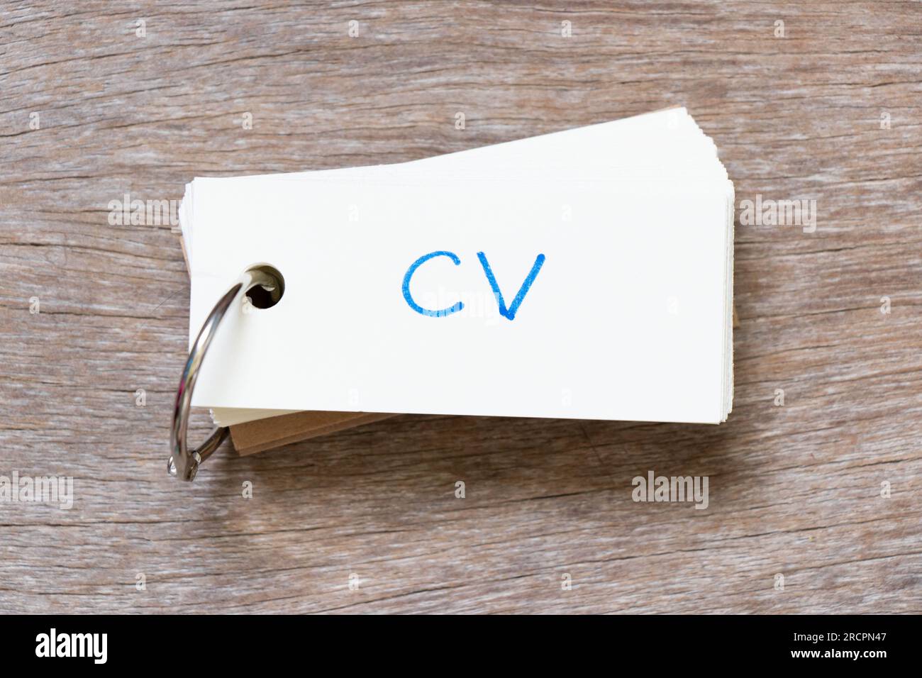 Flash card with handwriting in word CV (Abbreviation of curriculum ...