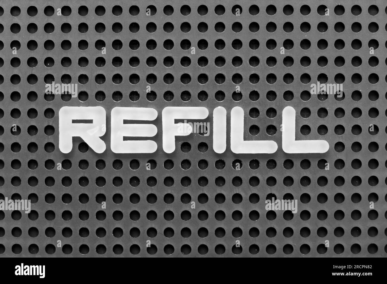 White alphabet letter in word refill on black pegboard background Stock ...