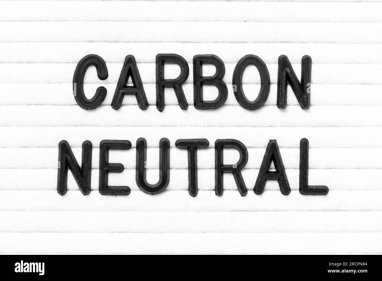 Black color letter in word carbon neutral on white felt board ...