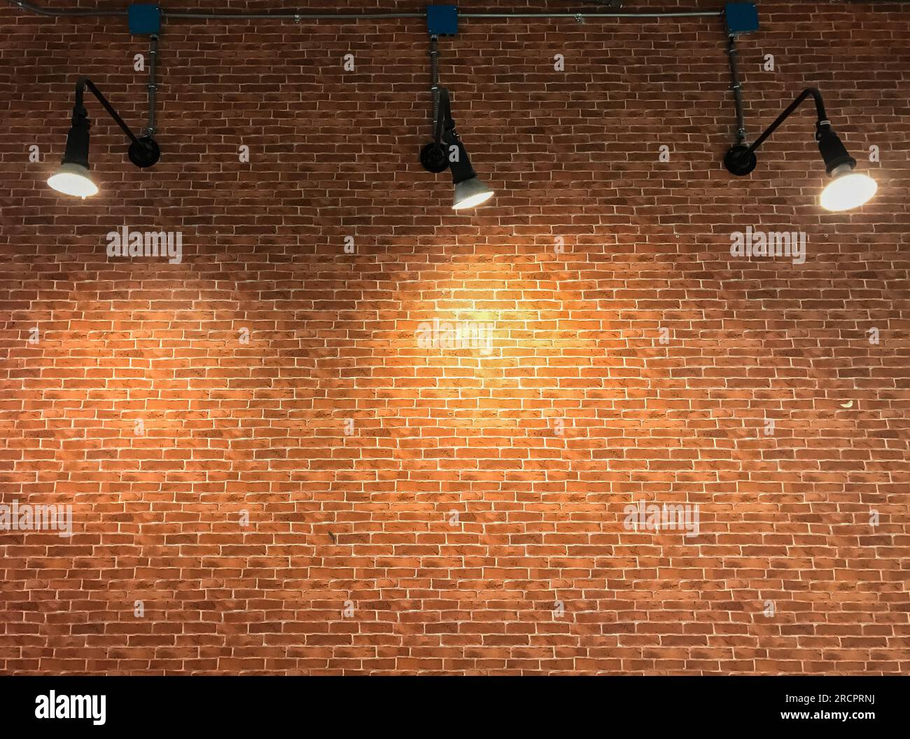 Spot light and brick background Stock Photo - Alamy