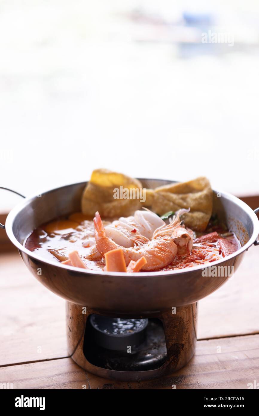 Seafood Tom Yum, hot and sour Thai soup with squid, shrimp served in ...