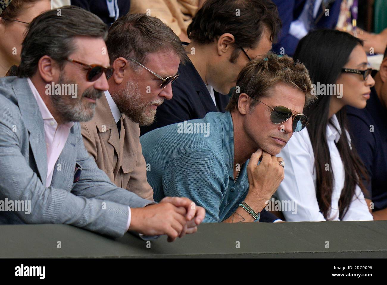 Actor Brad Pitt and director Guy Ritchie sit in the stands on Centre ...