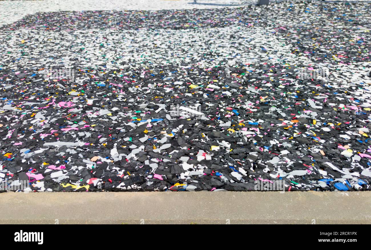 Flooring made from recycled rubber particles. Black cushion floor with ...