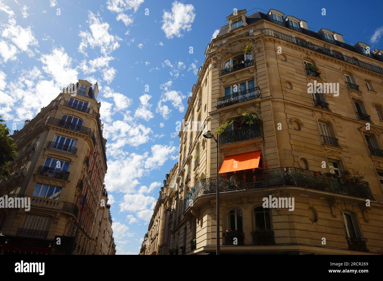 The facades of traditional French houses with typical balconies and ...