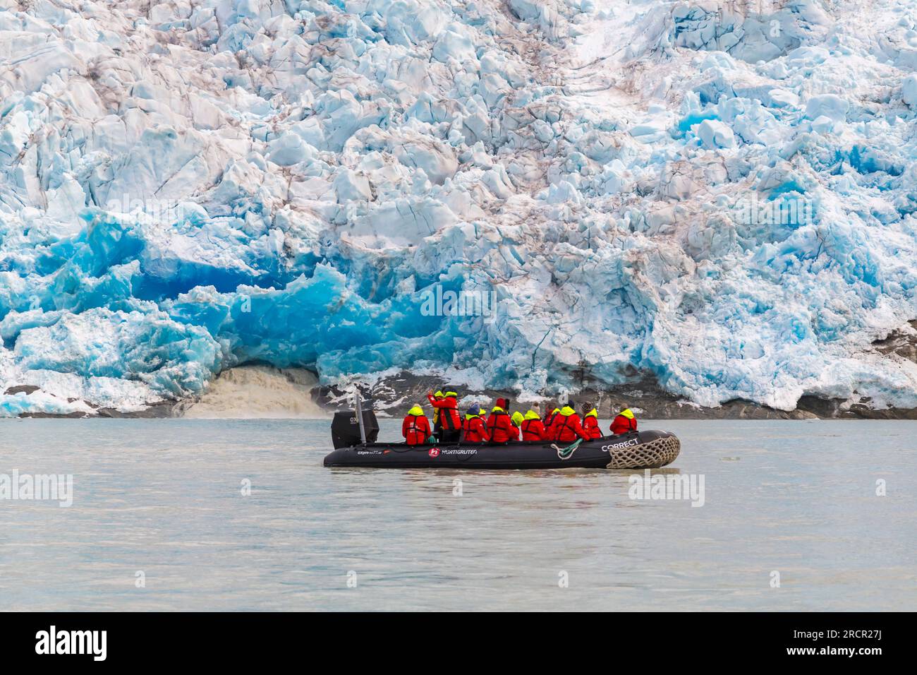 Tourists on zodiac get a close up view of glacier at Kvanefjord ...