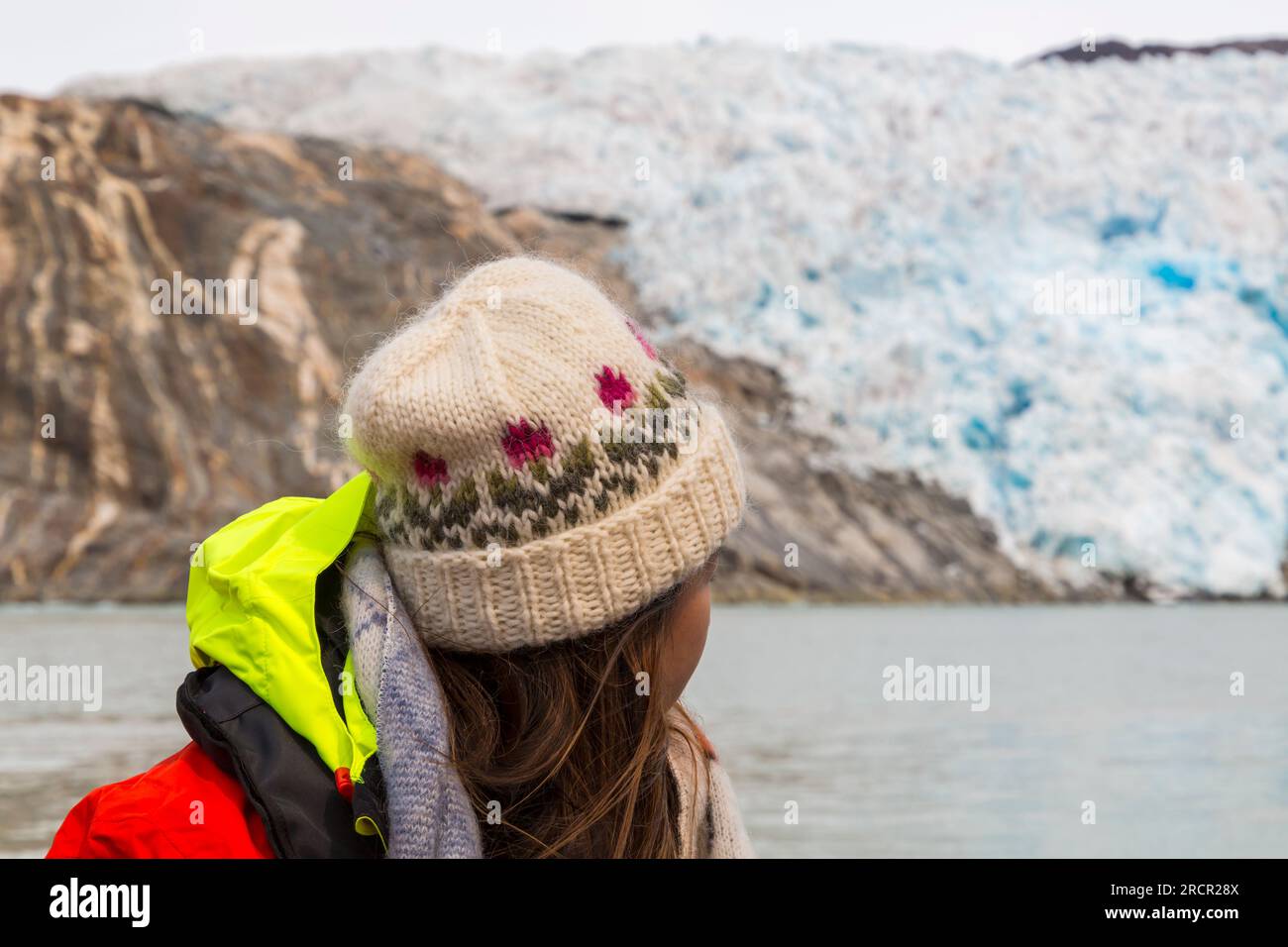Close up of tourist looking at glacier at Kvanefjord, Greenland in July ...
