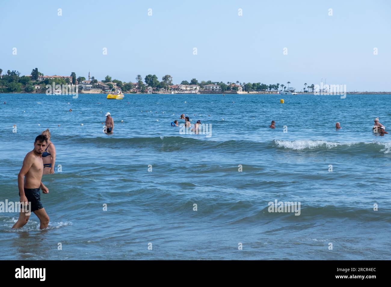 People Crowd Relaxing On Beach. Swimming people in sea Stock Photo - Alamy