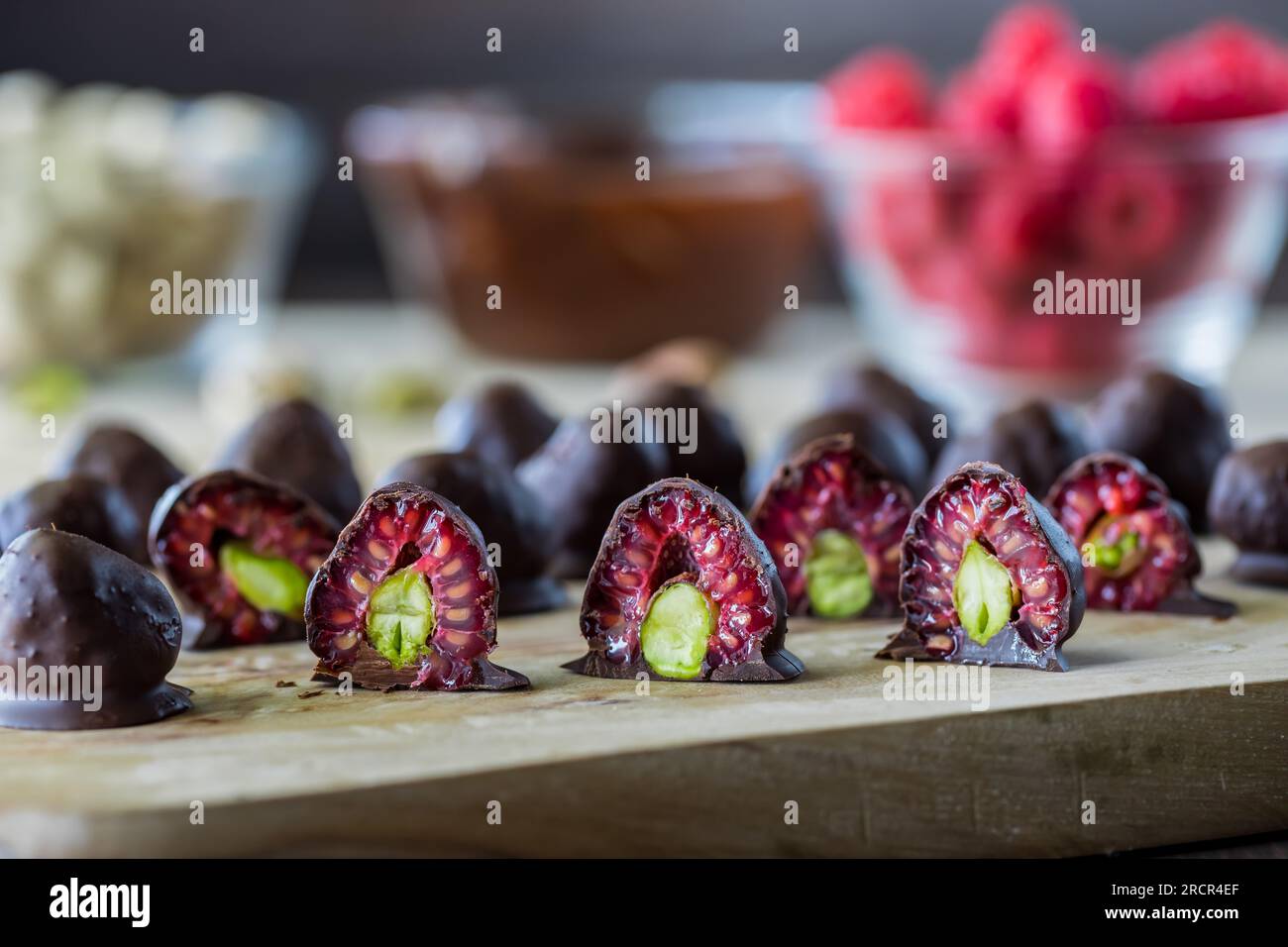 Chocolate covered pistachio filled raspberries with ingredients in ...