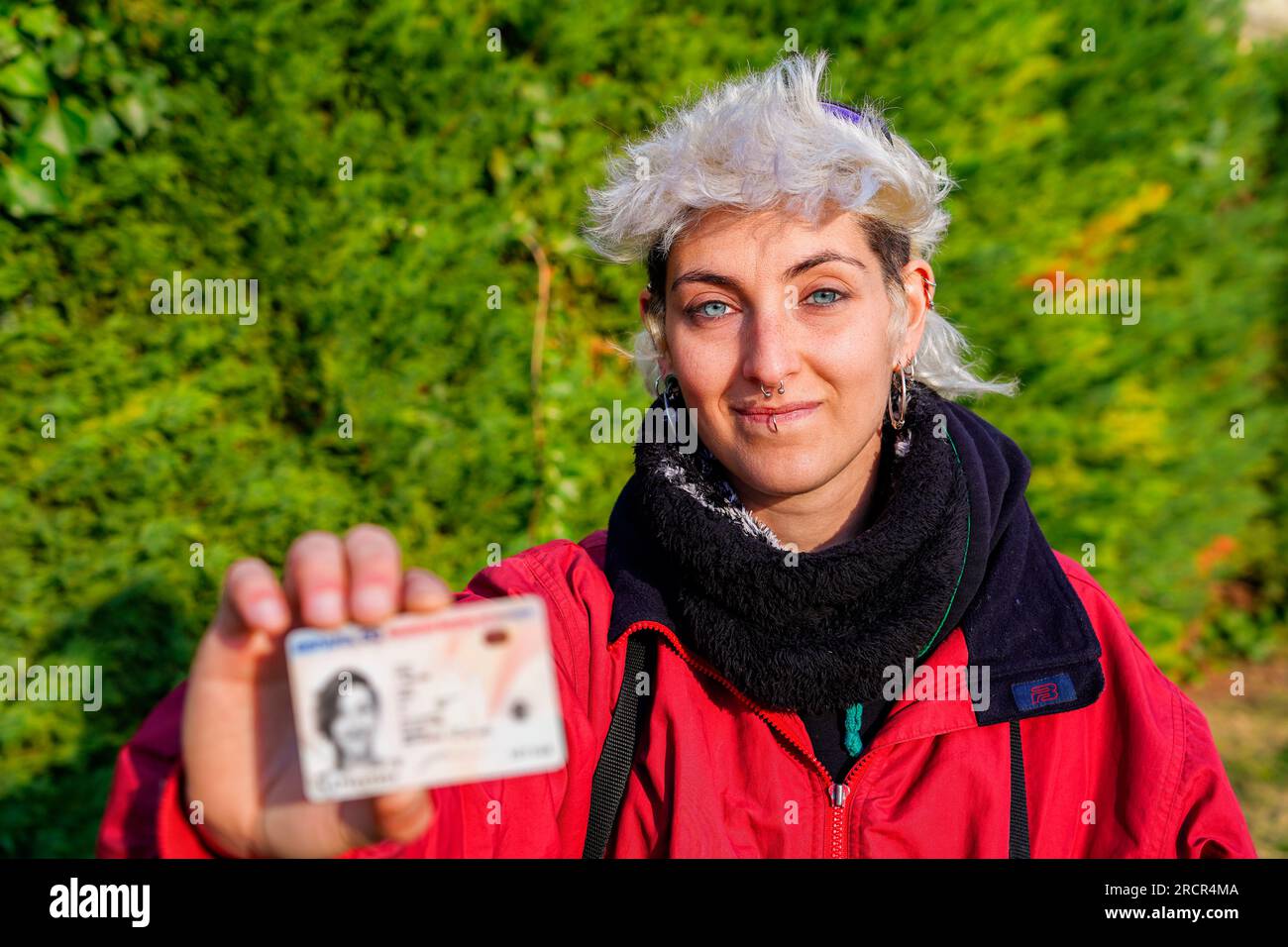 non-binary person showing their ID to camera Stock Photo - Alamy