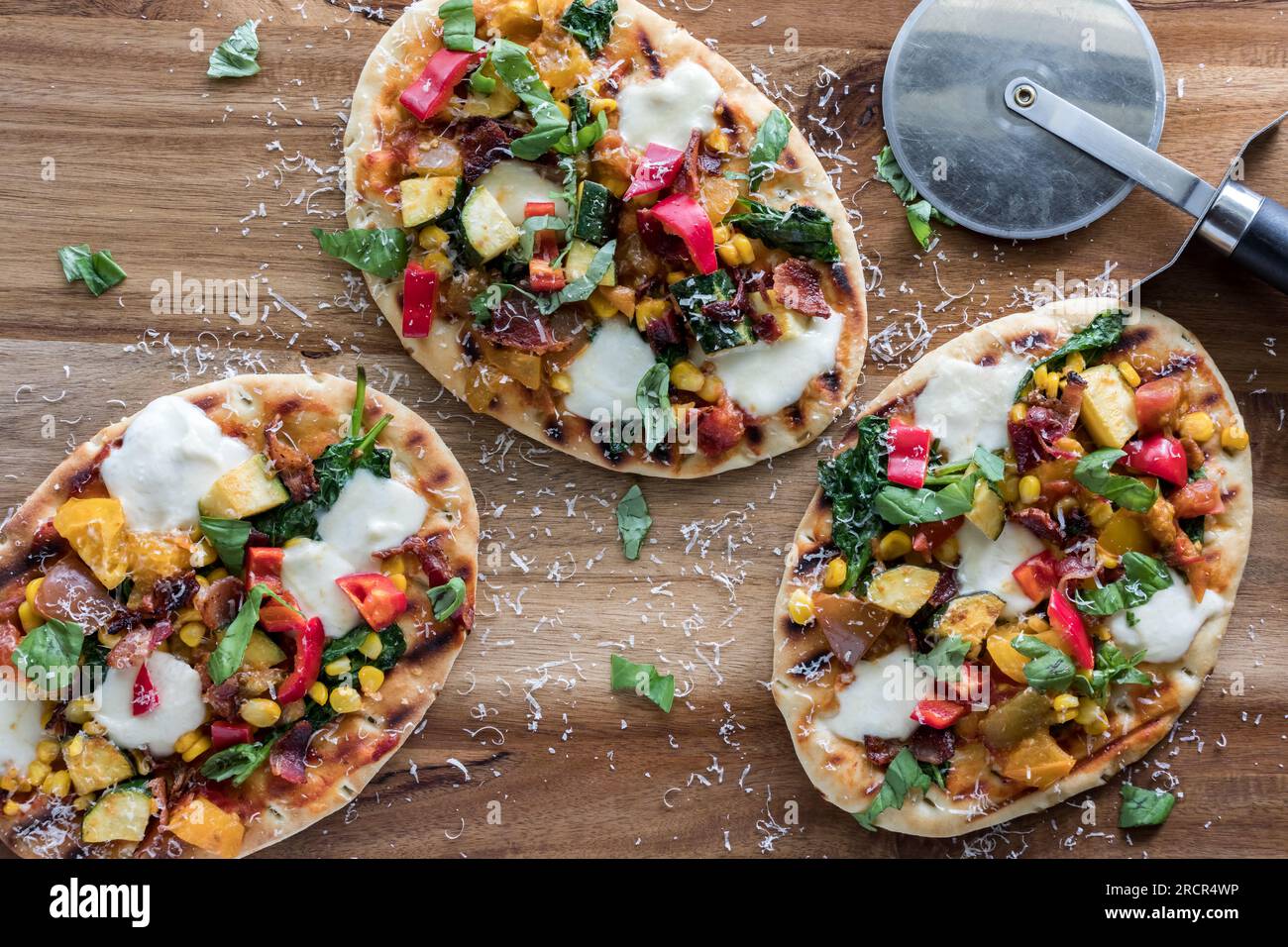 Whole homemade summer garden pizzas ready for slicing Stock Photo - Alamy