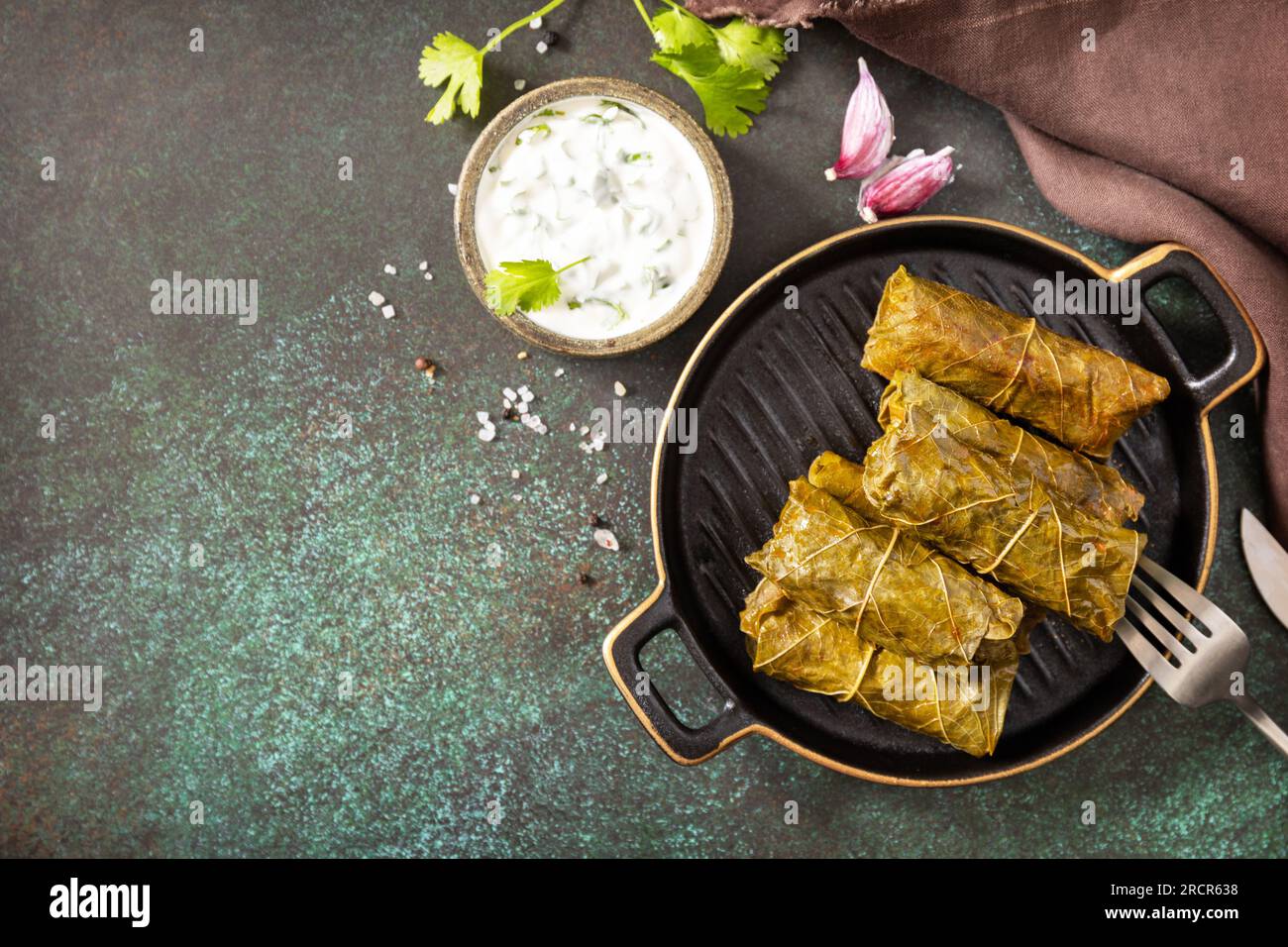 Delicious dolma - stuffed grape leaves with rice and meat on a dark ...