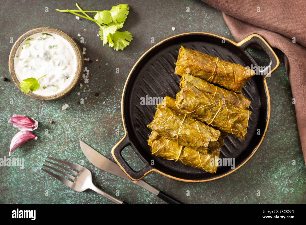 Delicious dolma - stuffed grape leaves with rice and meat on a dark ...