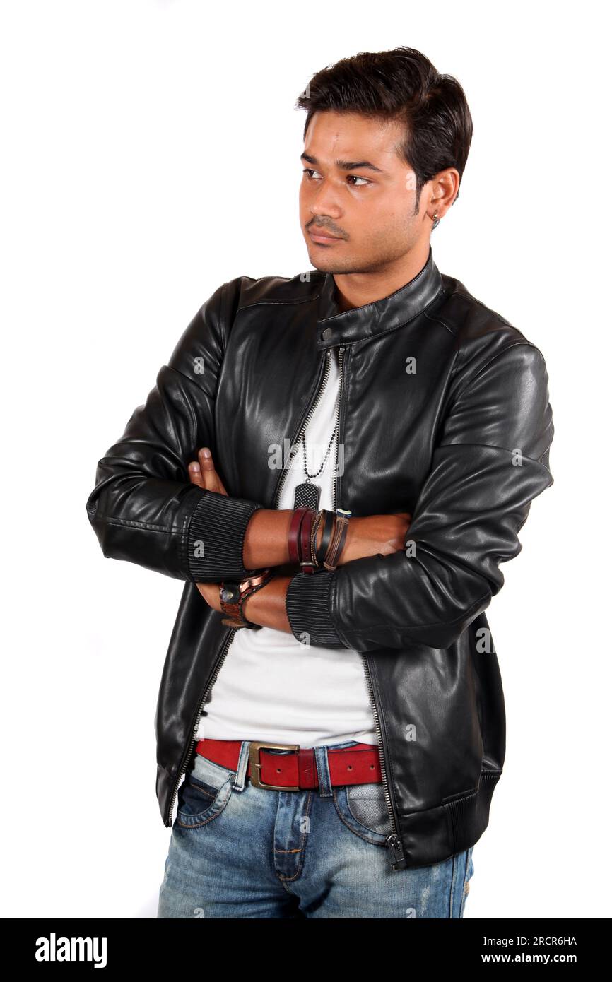 A young handsome Indian guy intently watching someone, on white studio ...