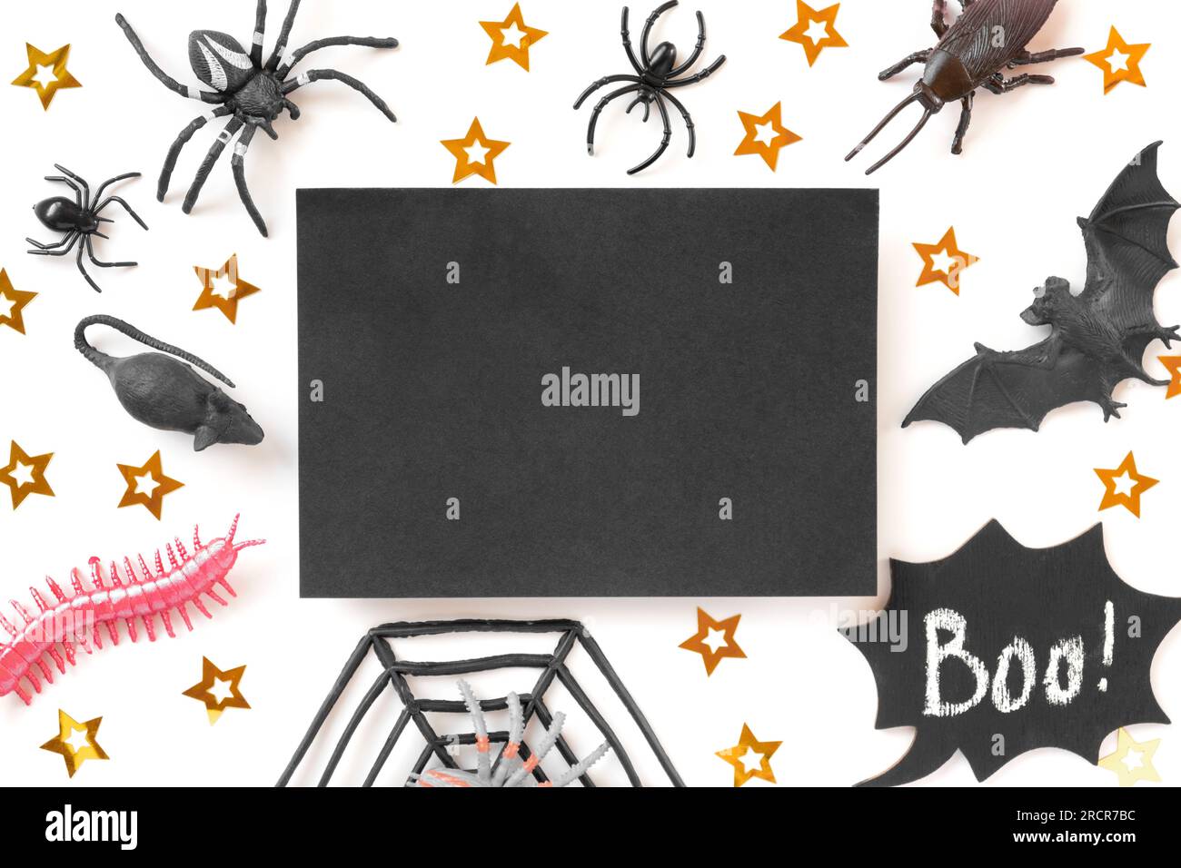 Black paper sheet on Halloween background with bats, spiders and golden ...