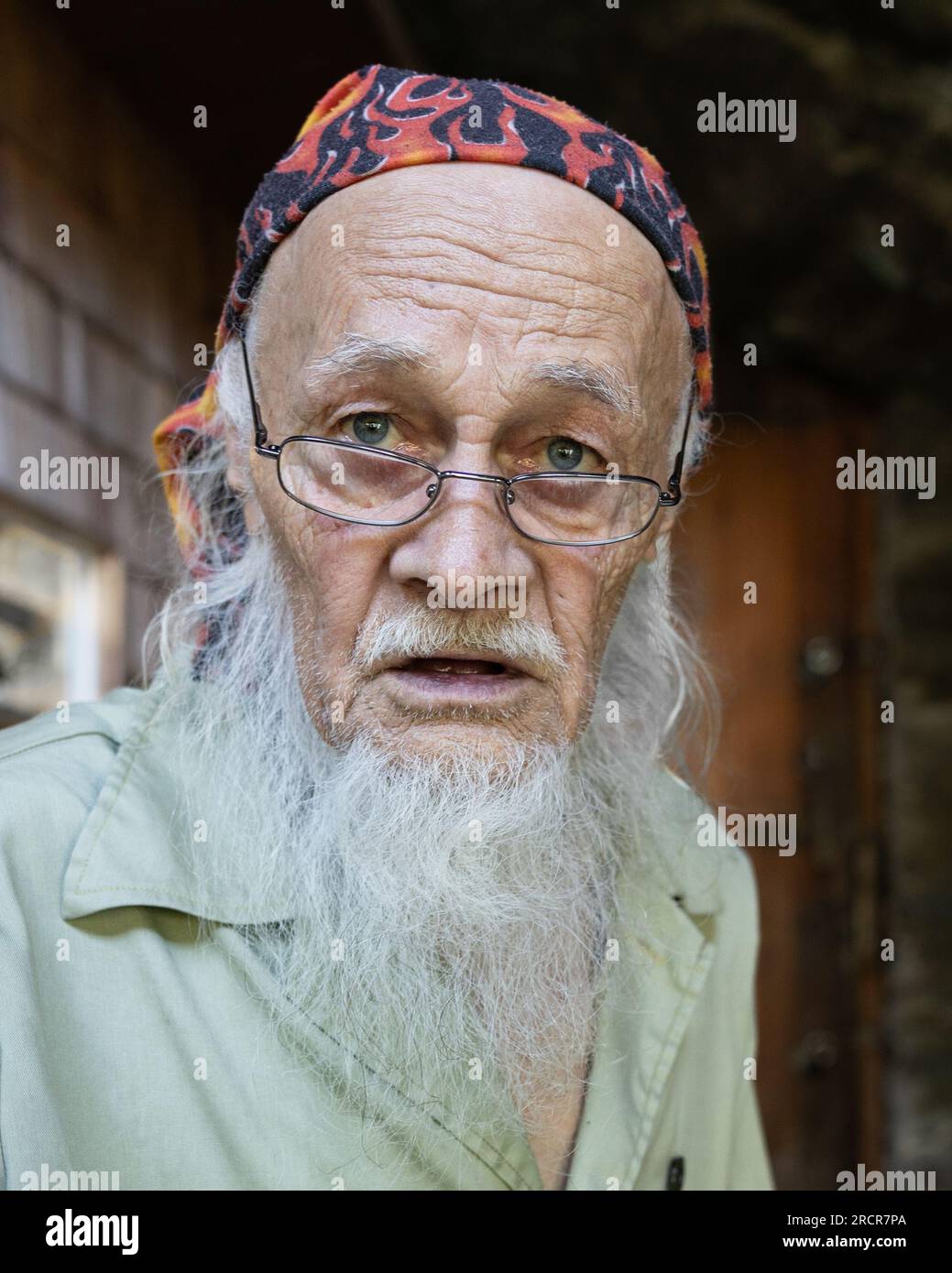 A large portrait of an old man with glasses, a gray beard and a ...