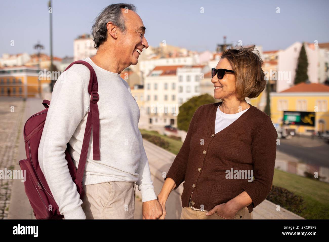 Happy Pensioners Couple Holding Hands Walking With Backpack Outdoors ...