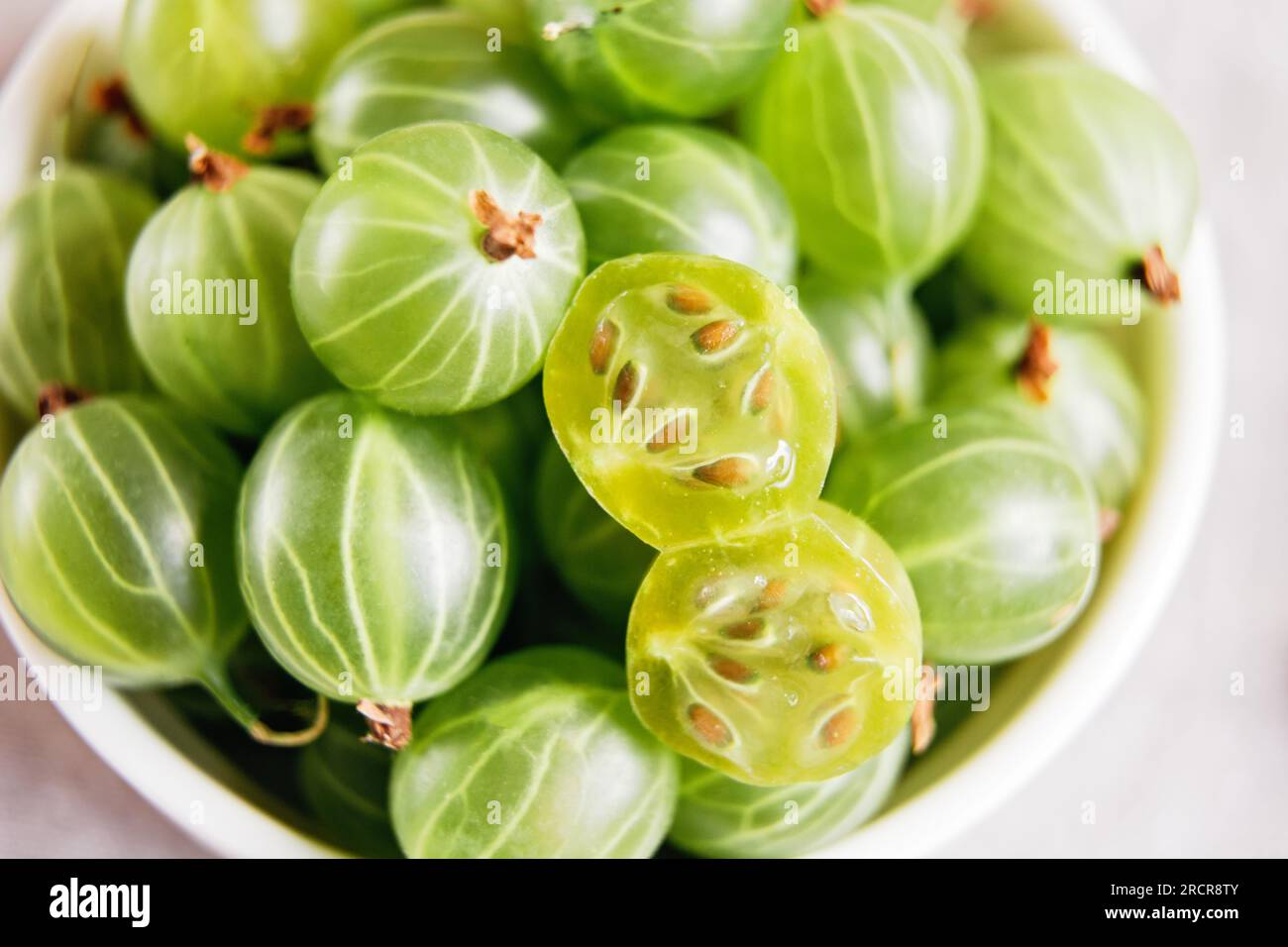 macro shot of a cut gooseberry fresh berries. Copy space. Vitamins ...