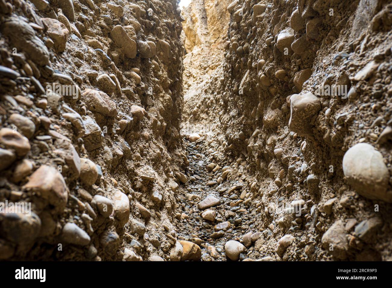 Close Up of A Narrow Path with Sandstone Walls With Round Rocks in the ...