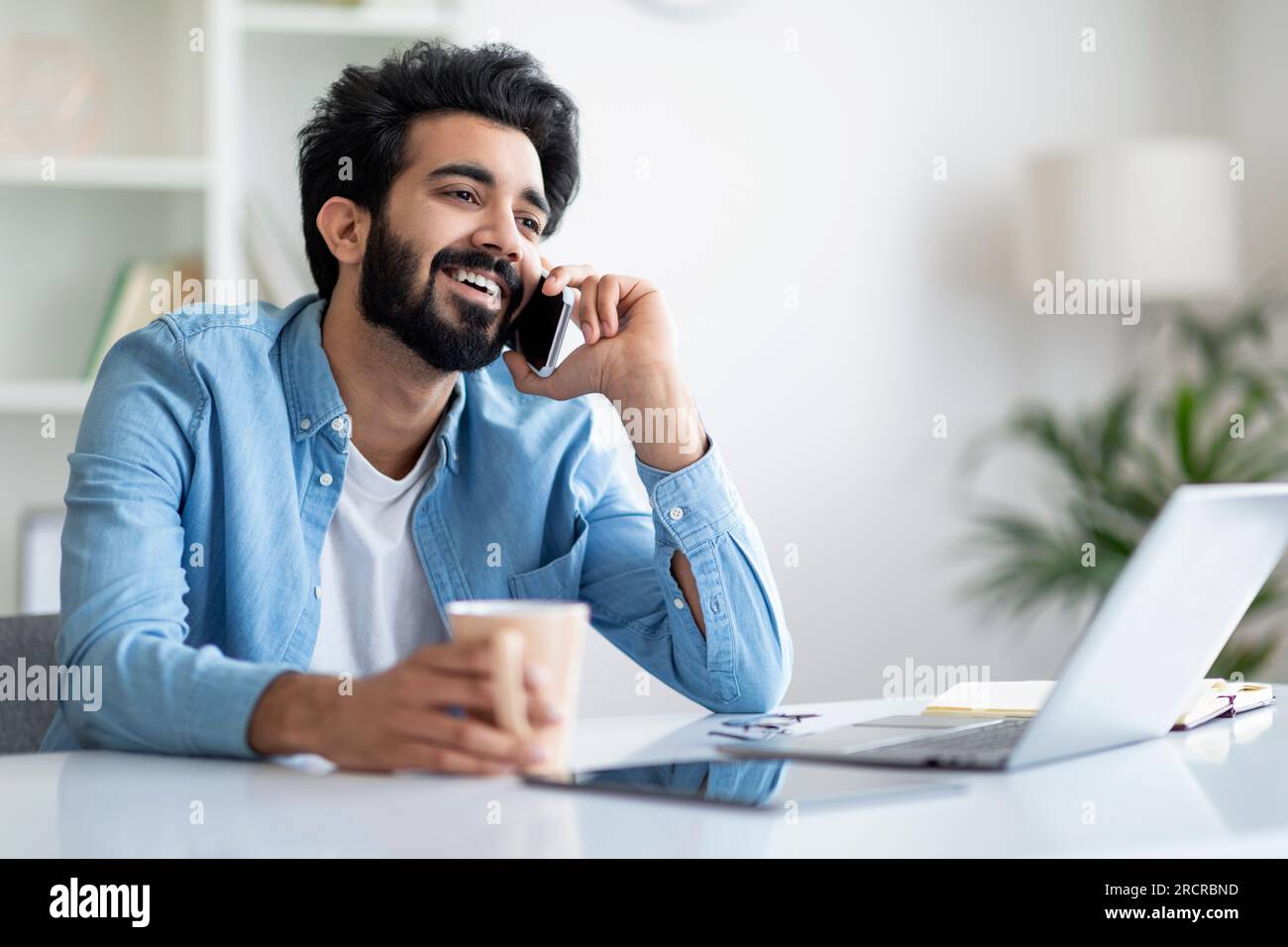Work Break. Indian Freelancer Guy Relaxing At Desk In Home Office Stock ...