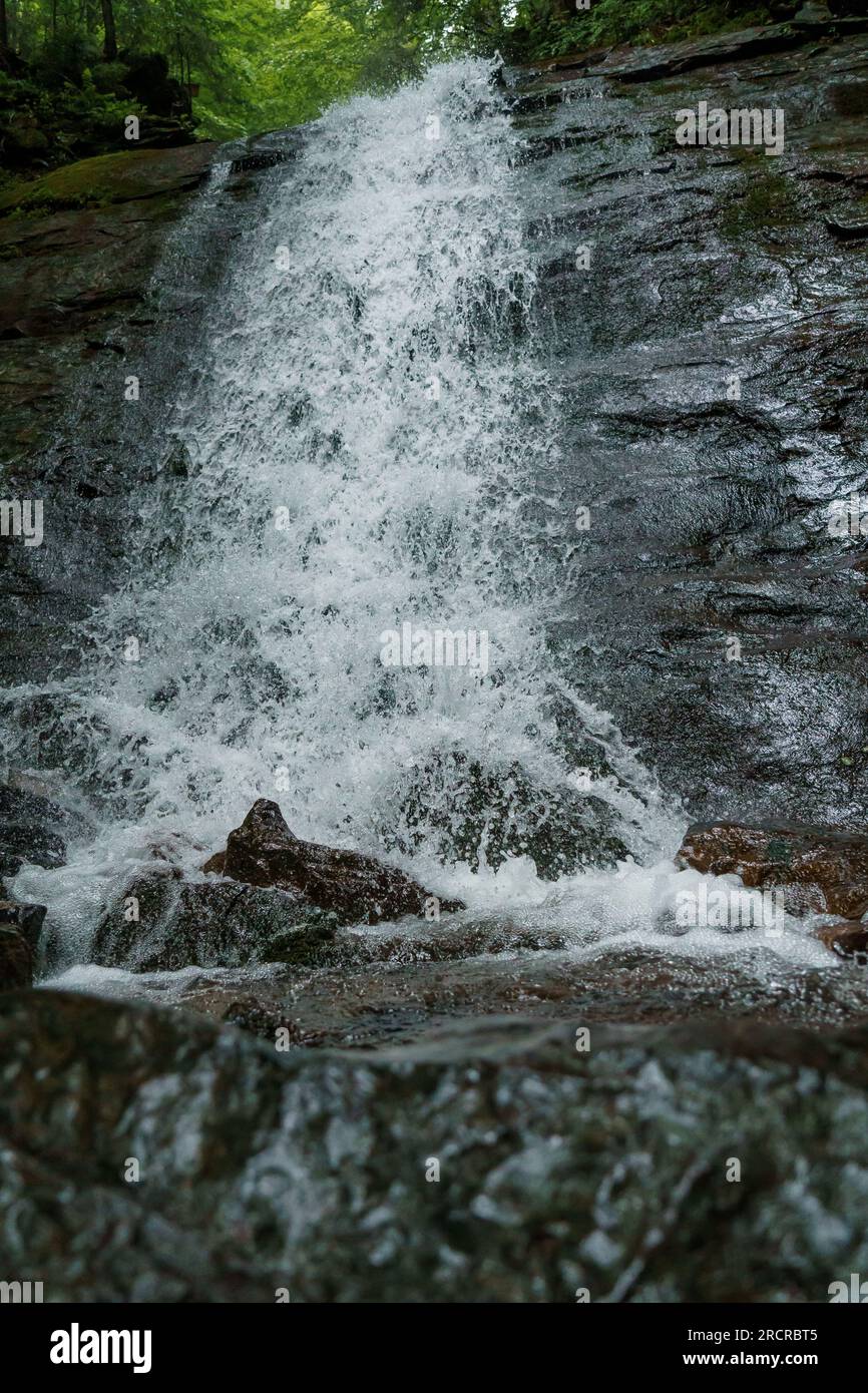 Waterfall cascade on mountain cliffs. Mountain waterfall in the ...