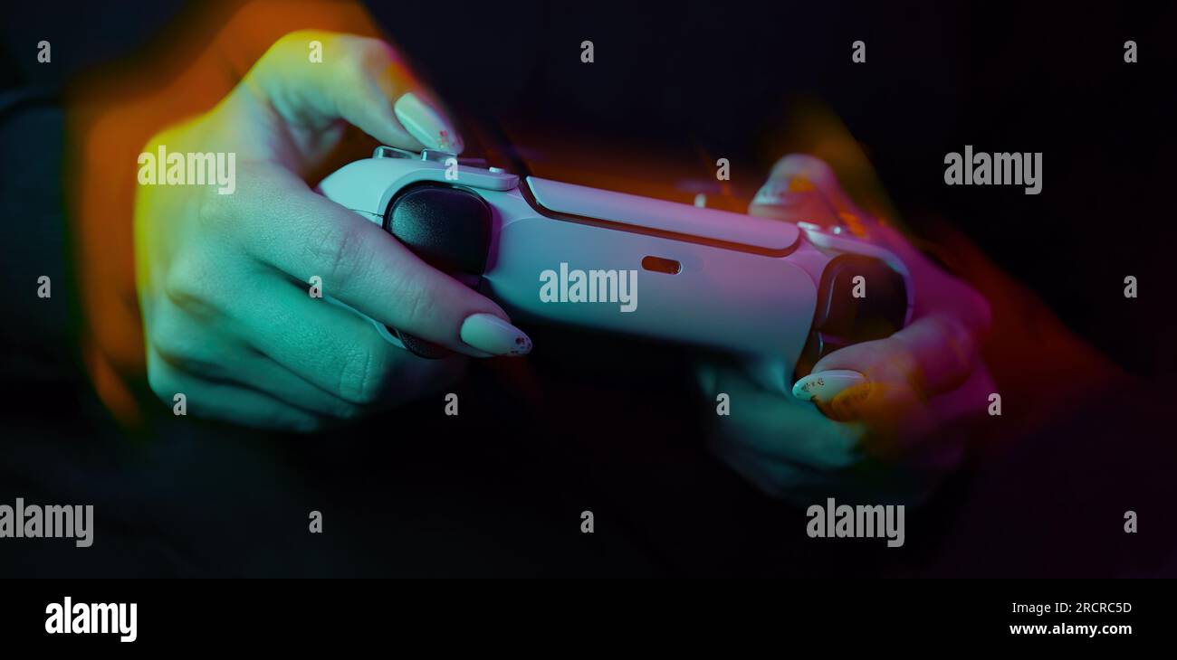 Gamer's hands playing online video game on console TV with joystick ...