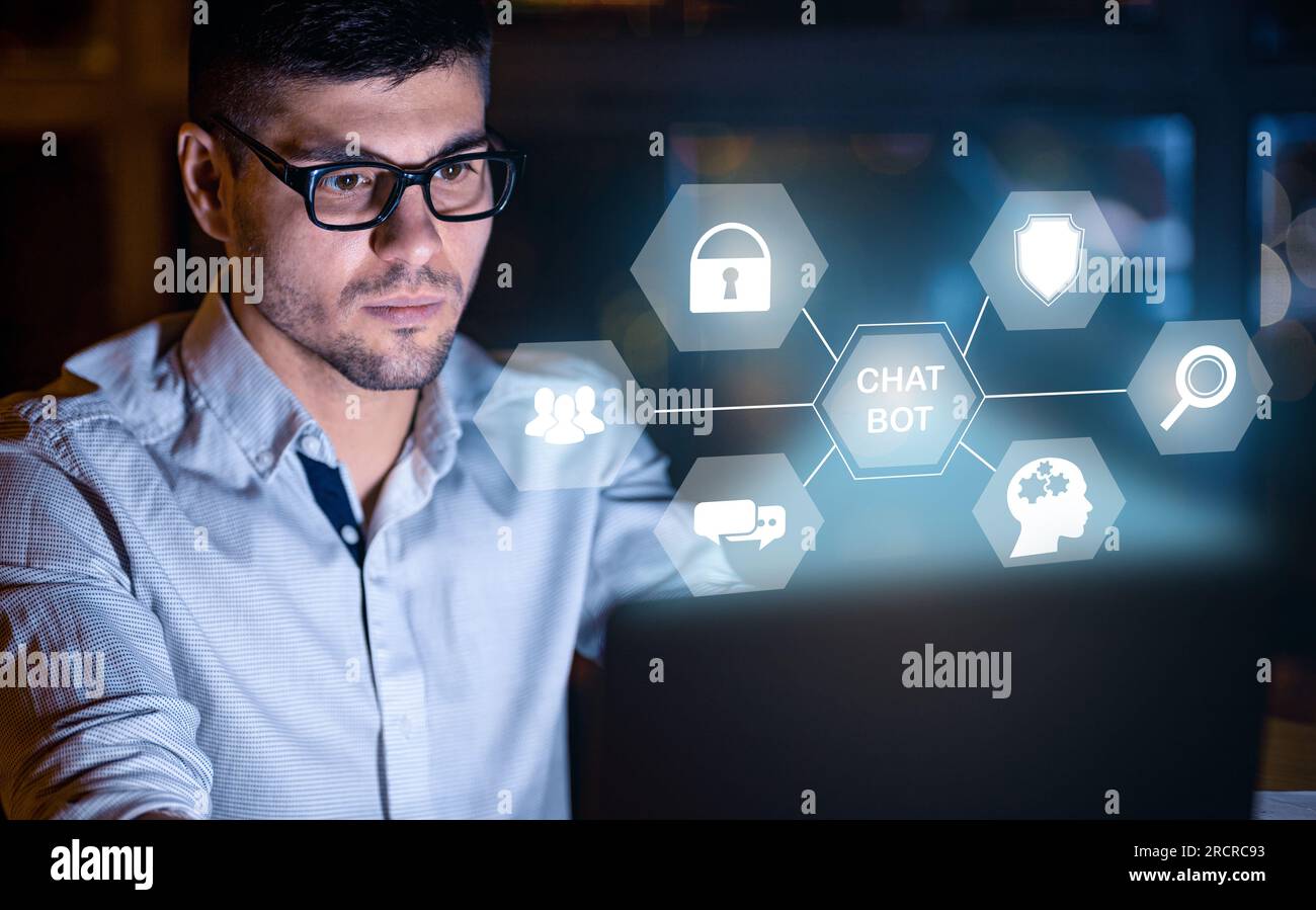 Young man wearing eyeglasses working on laptop, using artificial ...