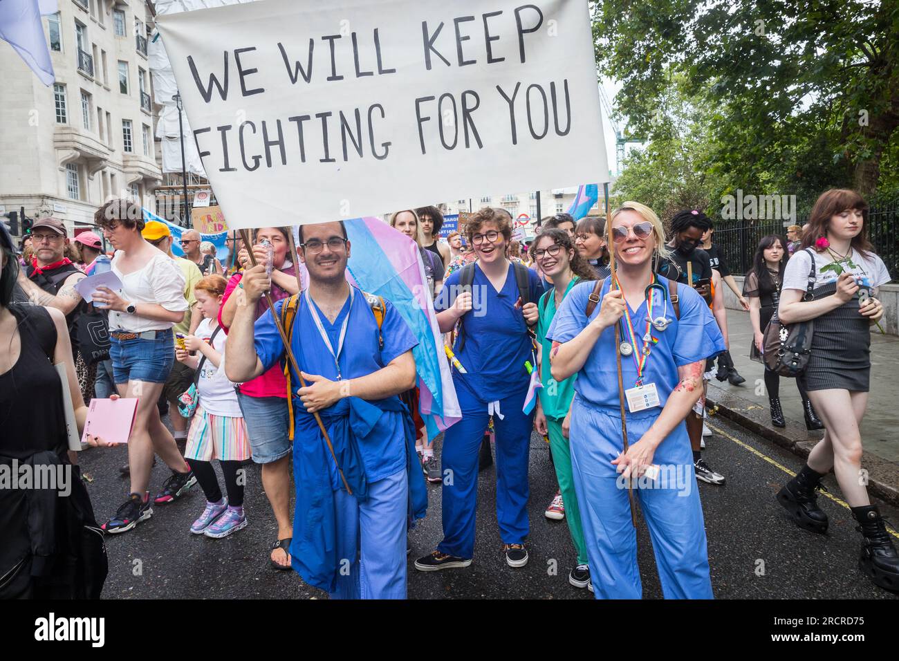 NHS staff in scrubs holding a banner supporting trans rights during ...