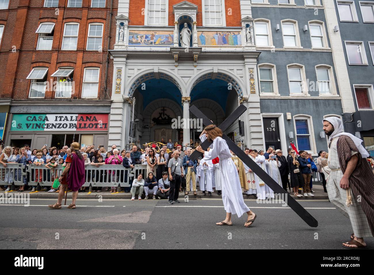 London, UK. 16 July 2023. A man playing Jesus carrying the cross ...