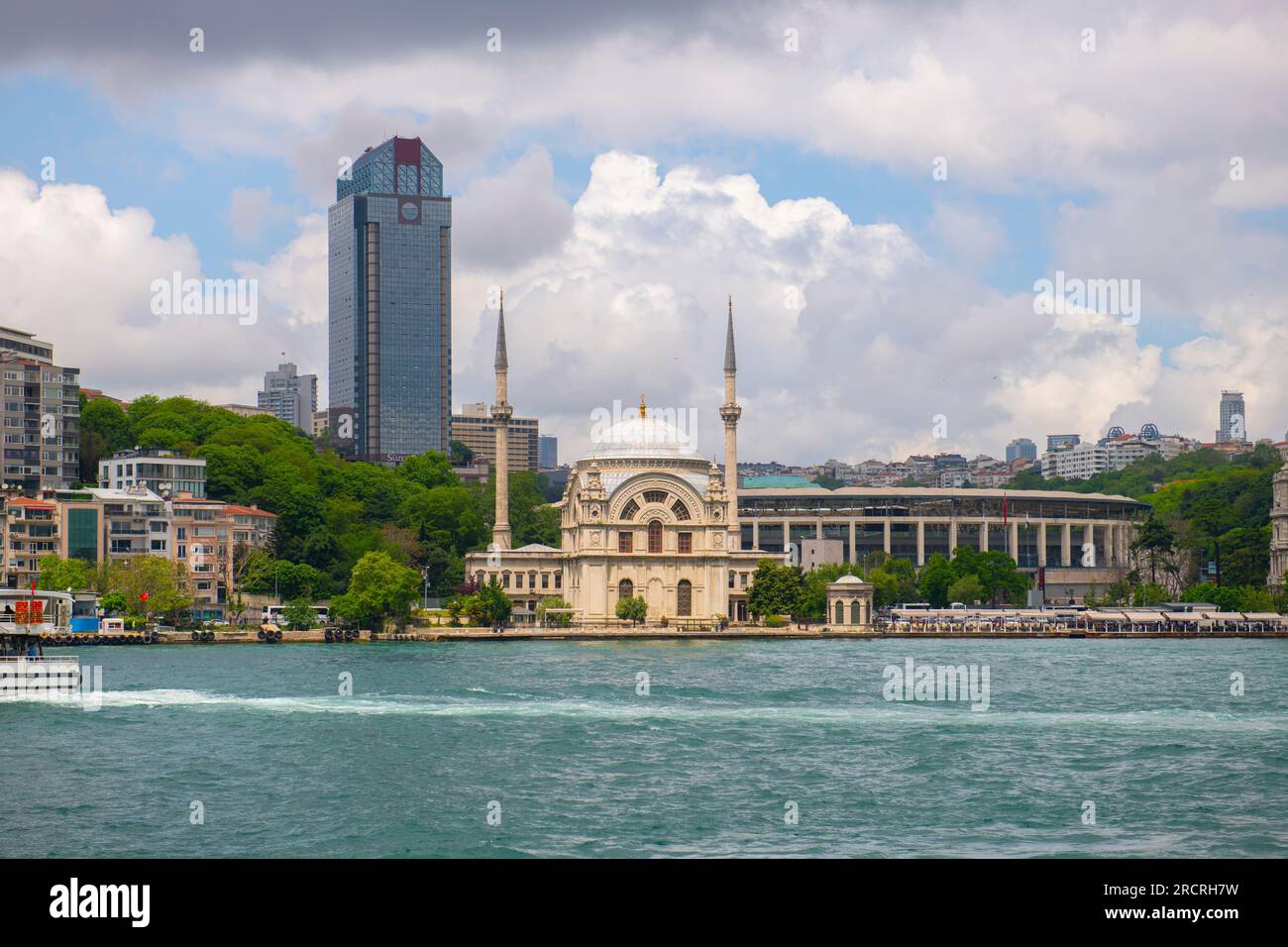 Dolmabahce Camii Mosque with Suzer Plaza building at the background at ...